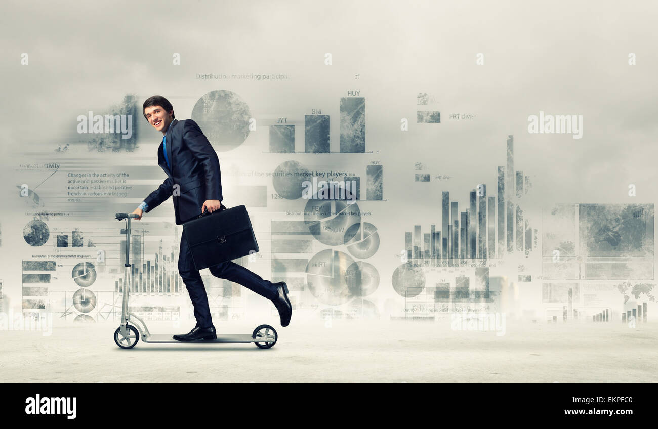 Businessman riding scooter Stock Photo - Alamy