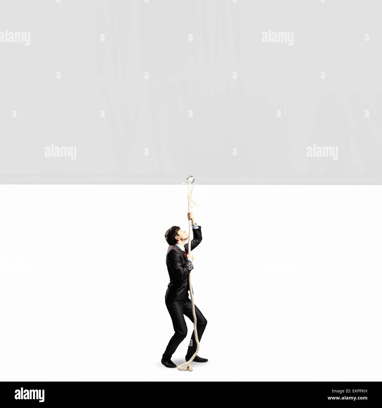 Businessman pulling banner Stock Photo - Alamy