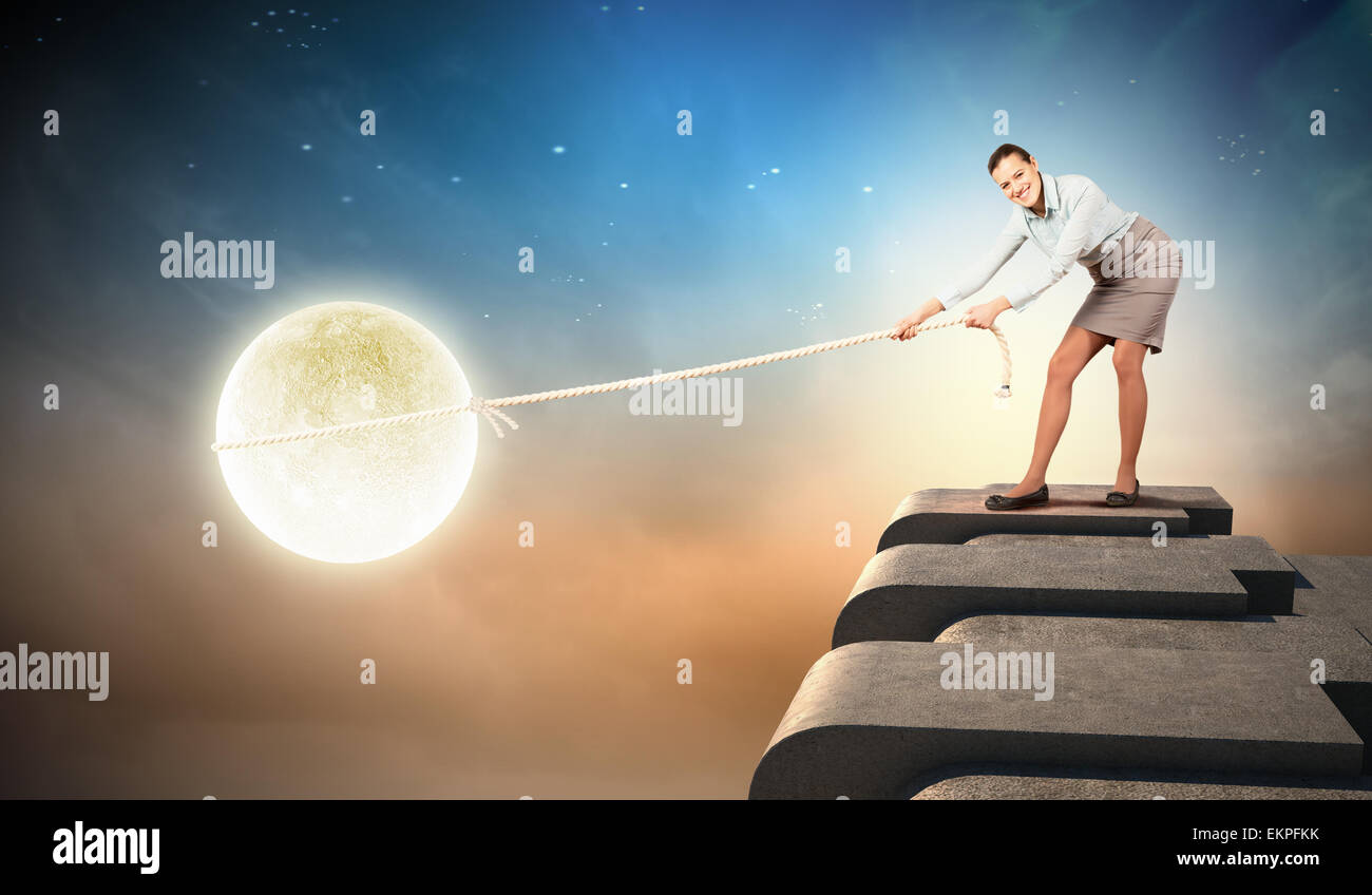 Woman pulling moon Stock Photo - Alamy