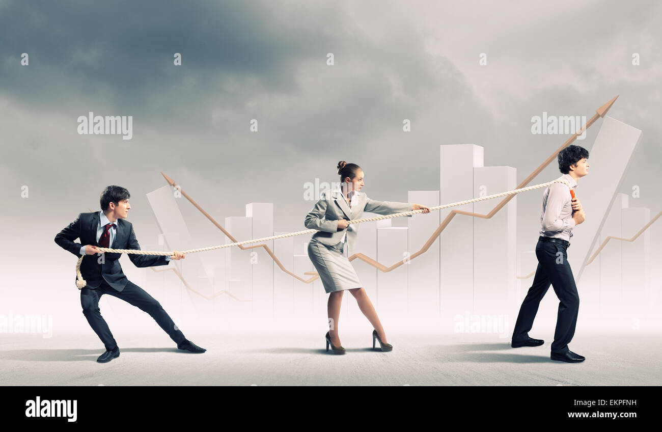 Three business people pulling rope Stock Photo - Alamy