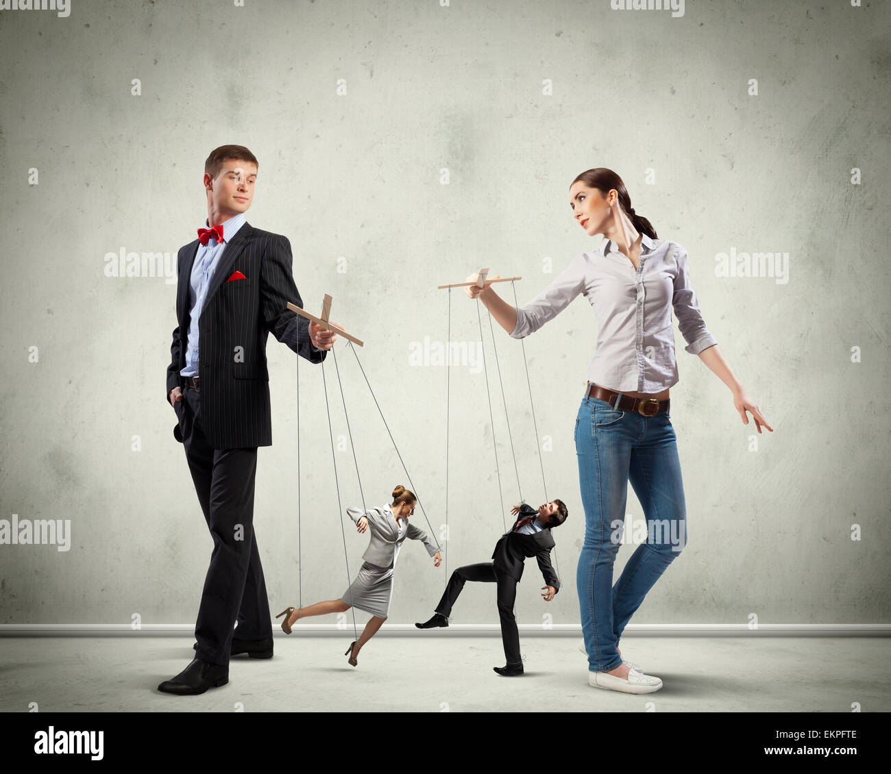 Image of man and woman with marionette puppets Stock Photo - Alamy