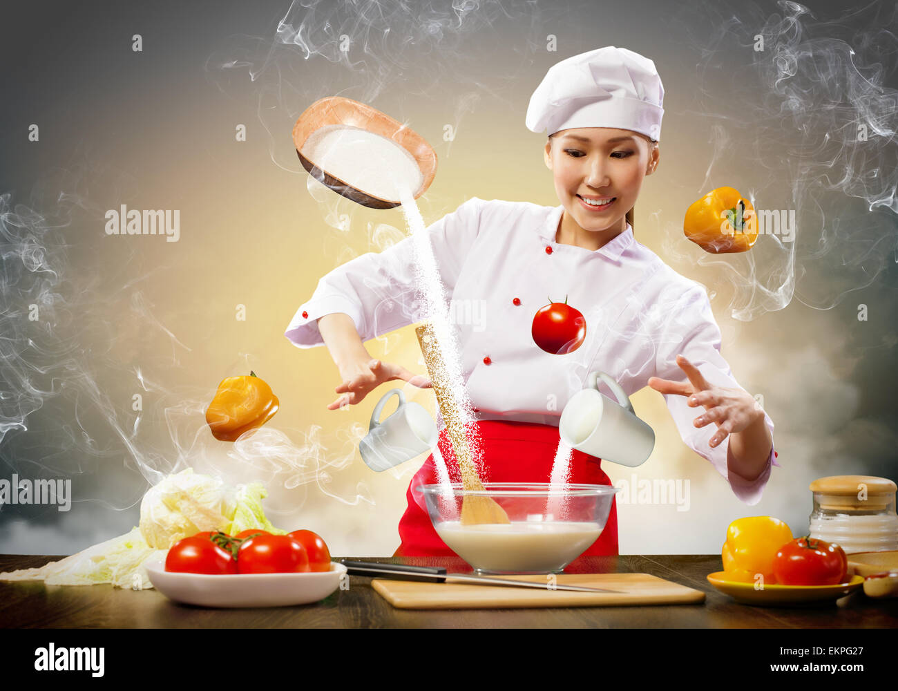 Asian female cooking with magic Stock Photo - Alamy