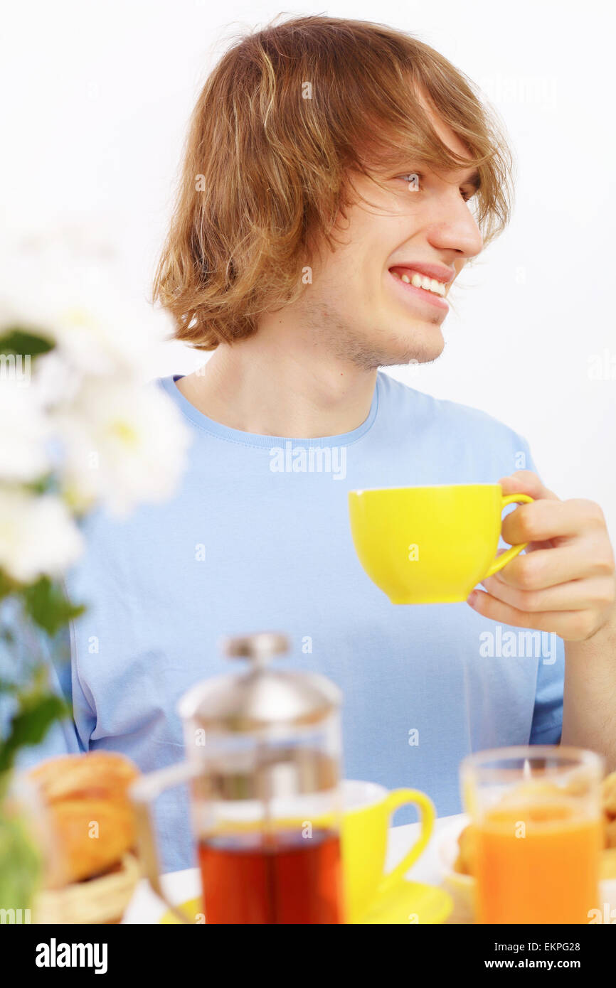 Young happy man drinking tea Stock Photo - Alamy