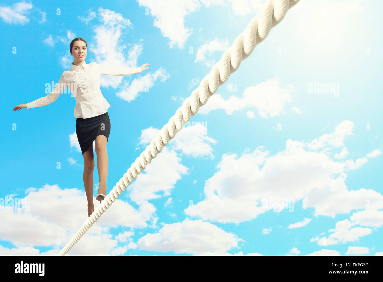 Businesswoman balancing on rope Stock Photo - Alamy