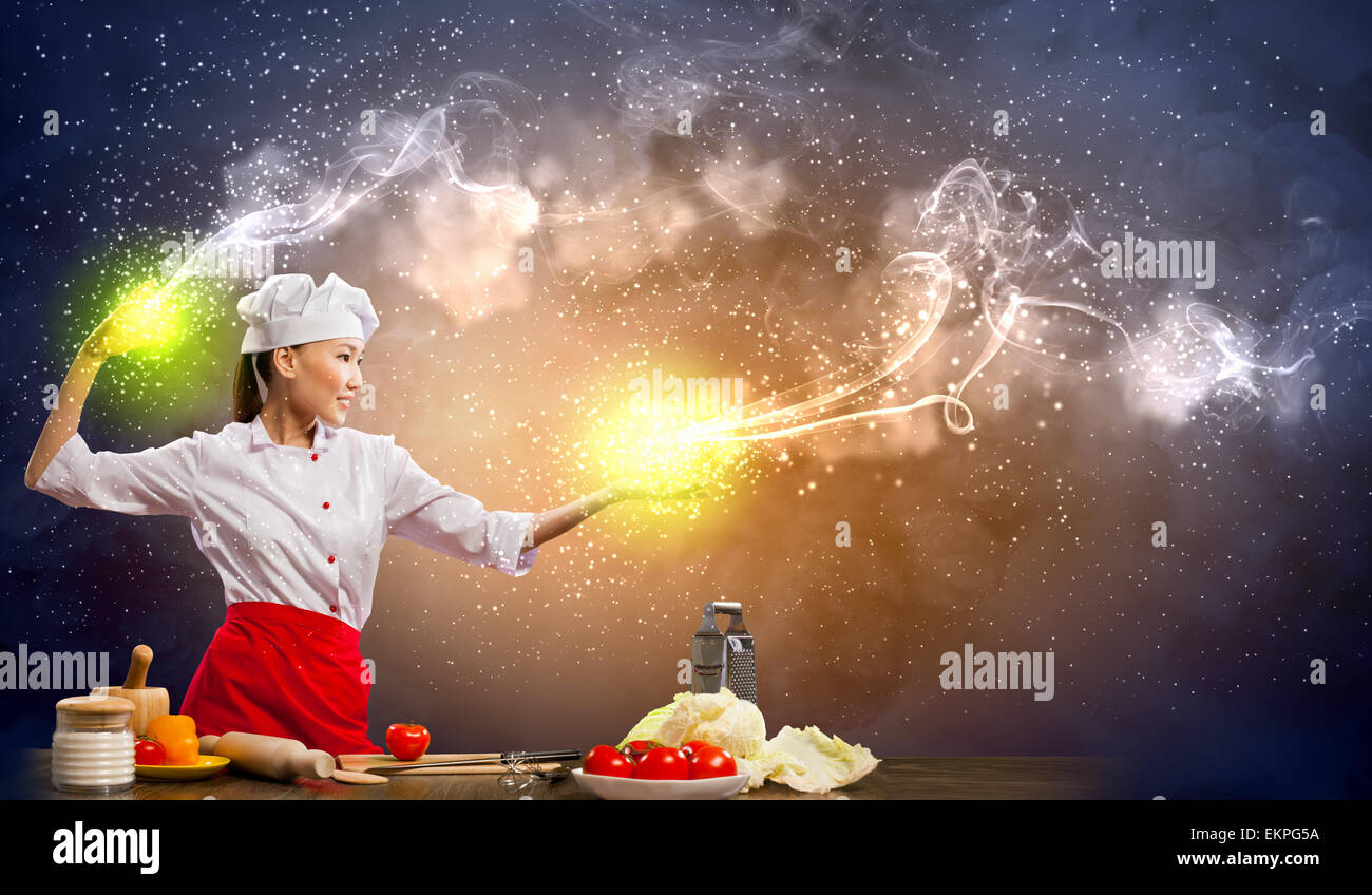 Asian female cooking with magic Stock Photo - Alamy
