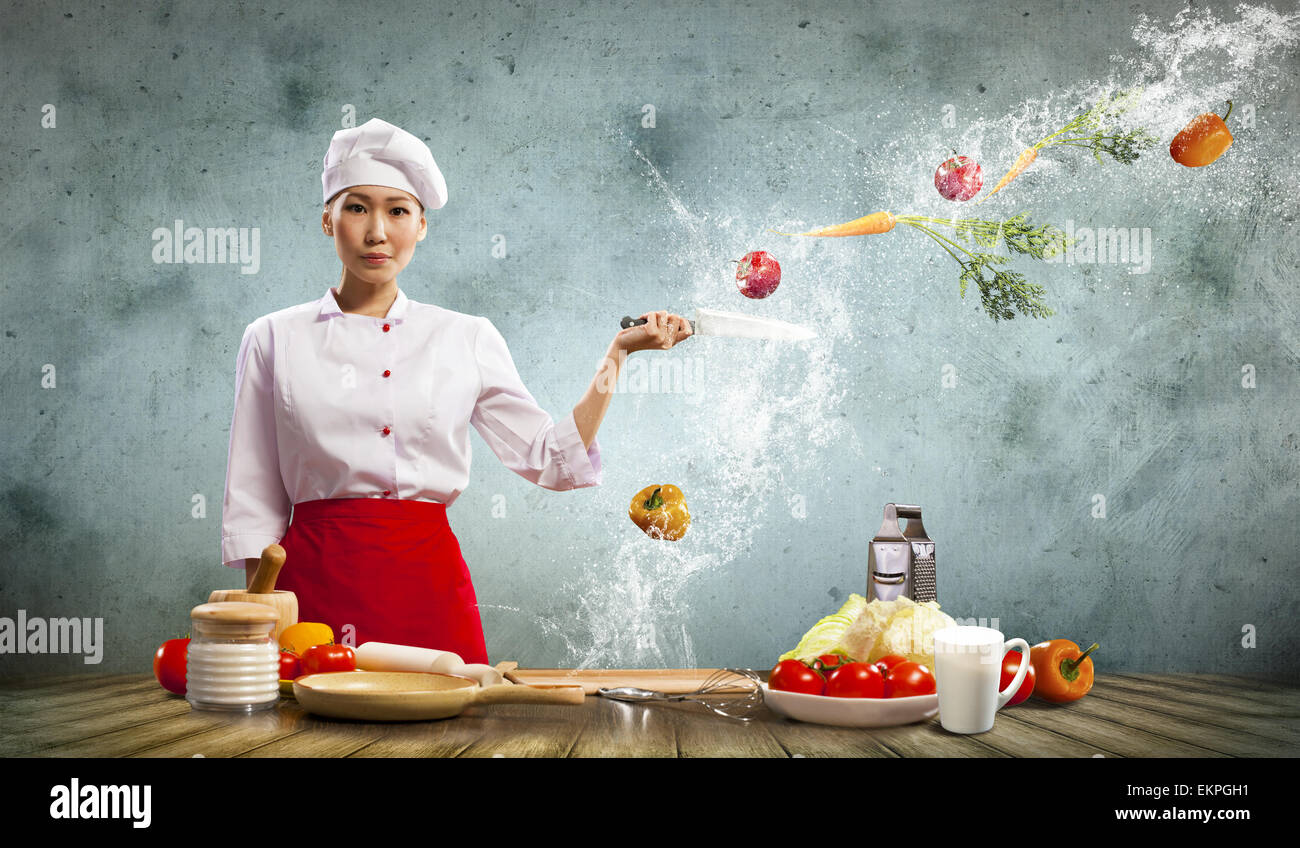 Asian female cook with knife Stock Photo - Alamy