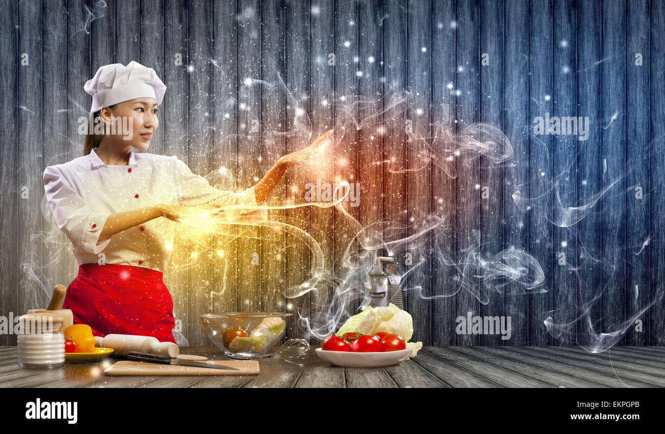 Asian female cooking with magic Stock Photo - Alamy