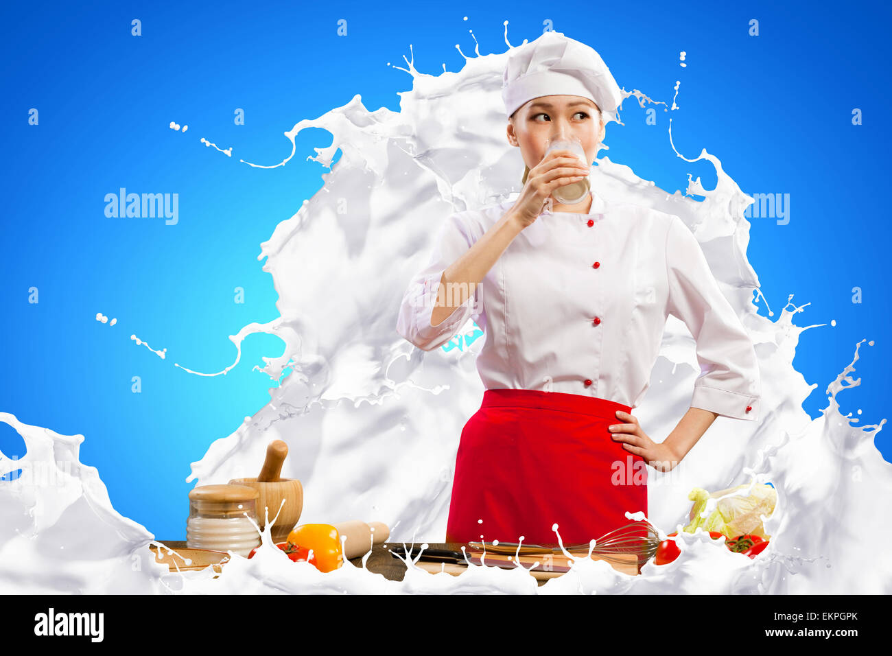Asian female cook against milk splashes Stock Photo - Alamy