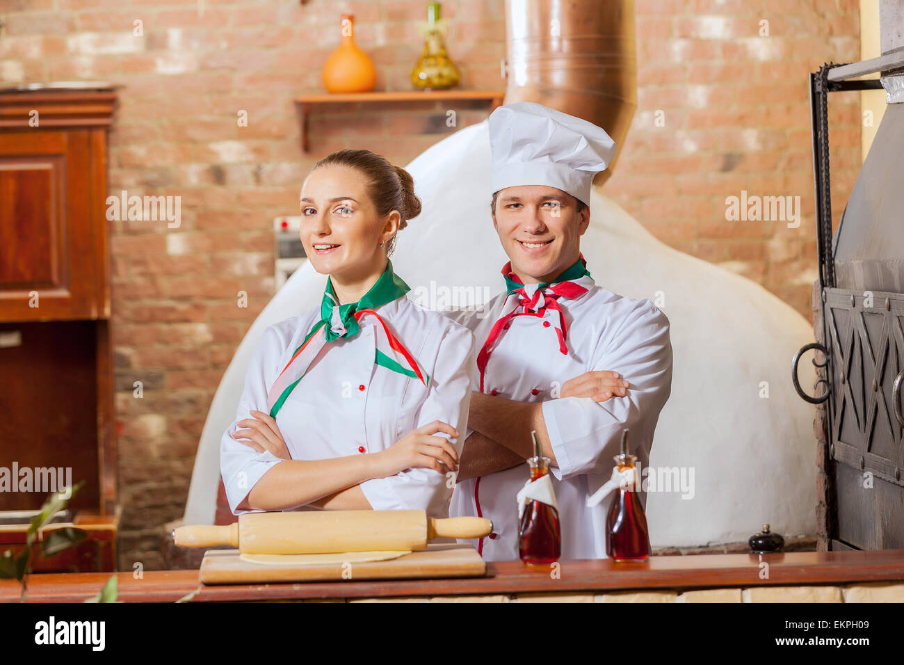 Portrait of two cooks with crossed arms Stock Photo - Alamy