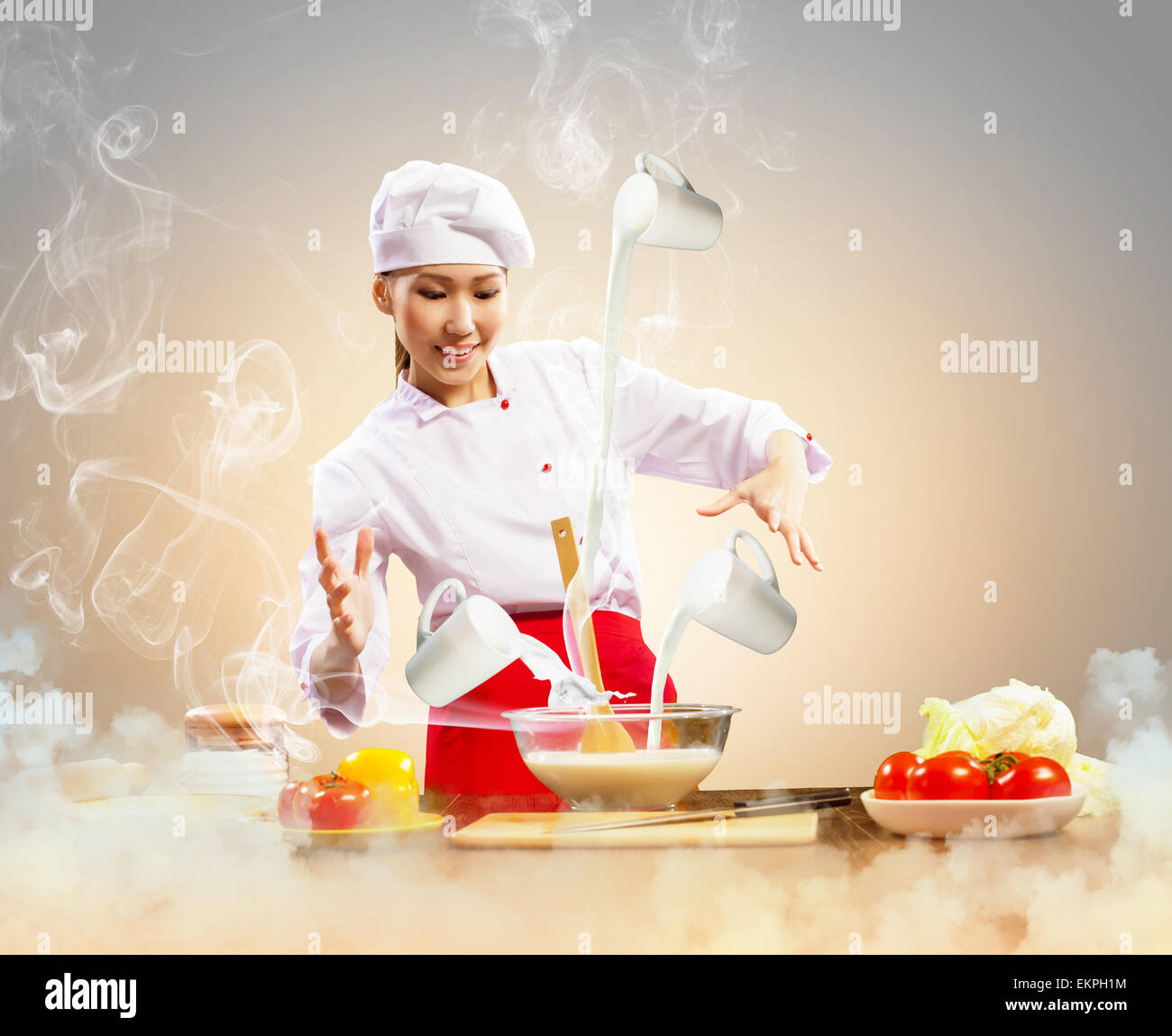 Asian female cooking with magic Stock Photo - Alamy