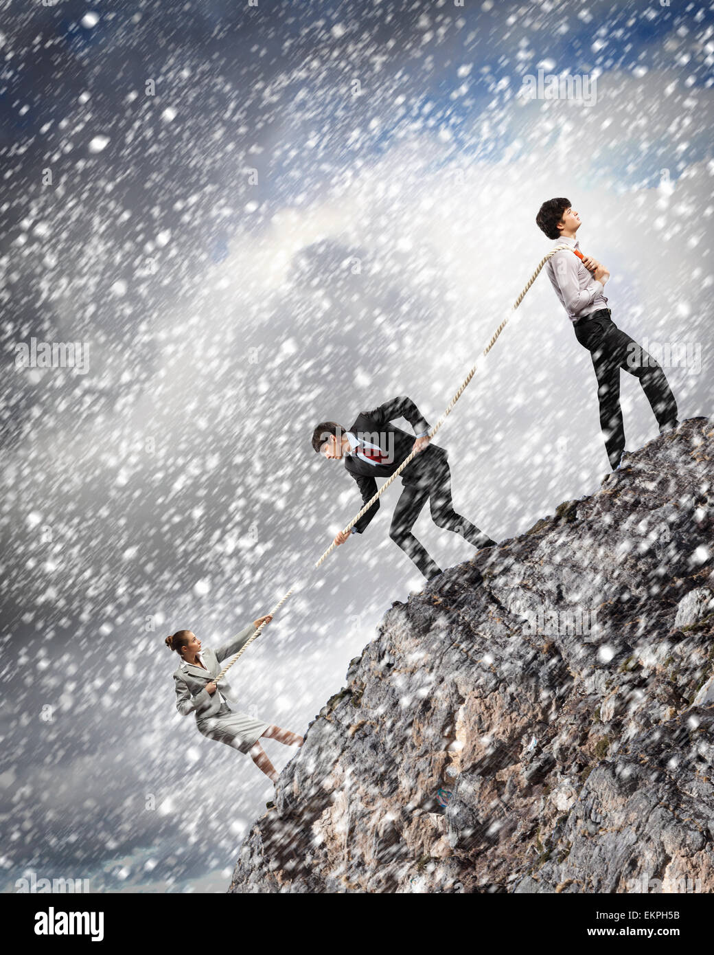 Three business people pulling rope Stock Photo - Alamy