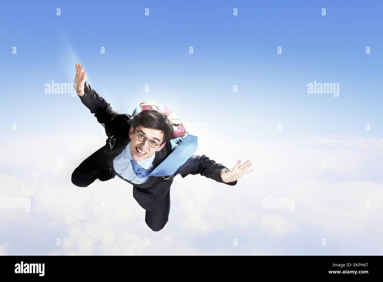 Young businessman flying with parachute on back Stock Photo - Alamy