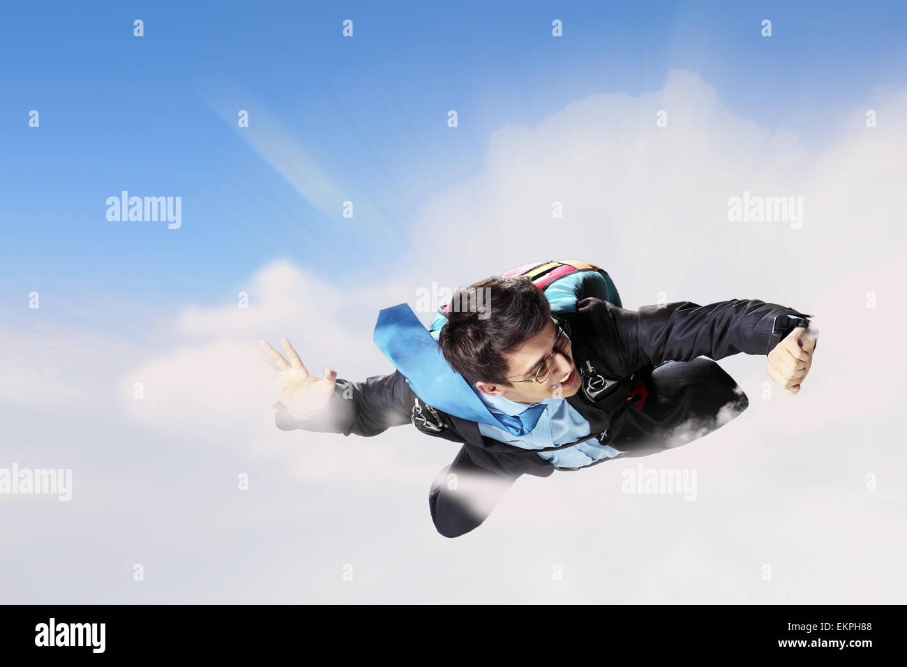 Young businessman flying with parachute on back Stock Photo - Alamy