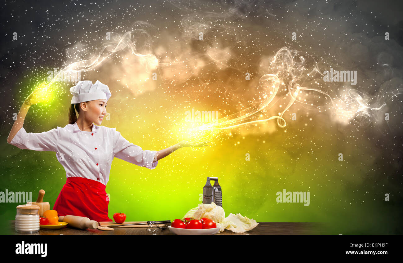 Asian female cooking with magic Stock Photo - Alamy