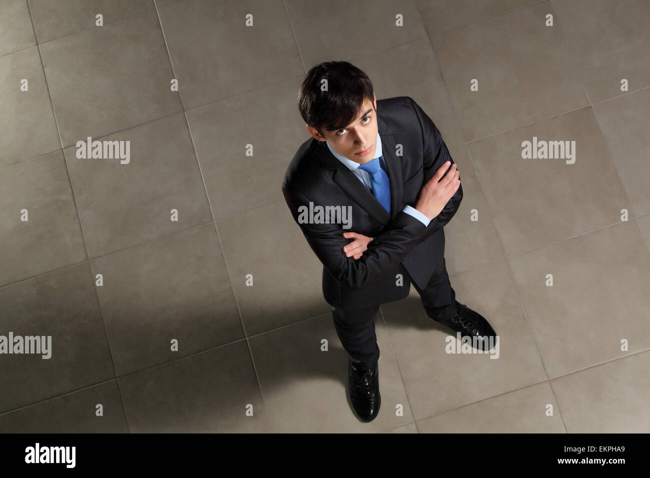Young businessman looking above Stock Photo - Alamy