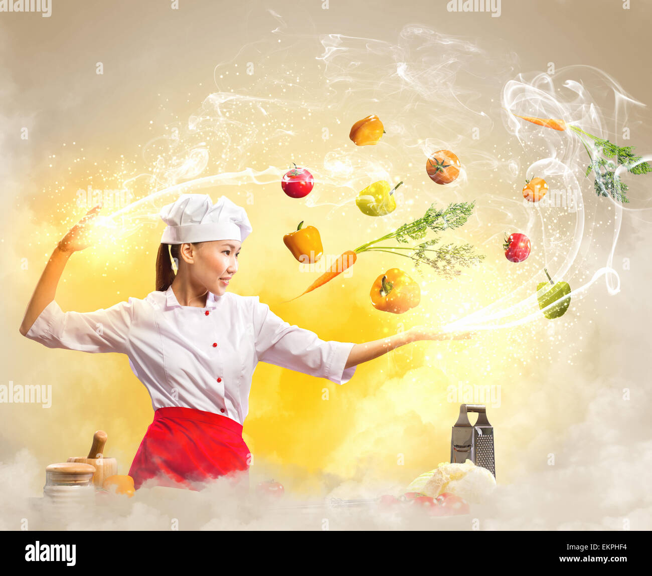 Asian female cooking with magic Stock Photo - Alamy
