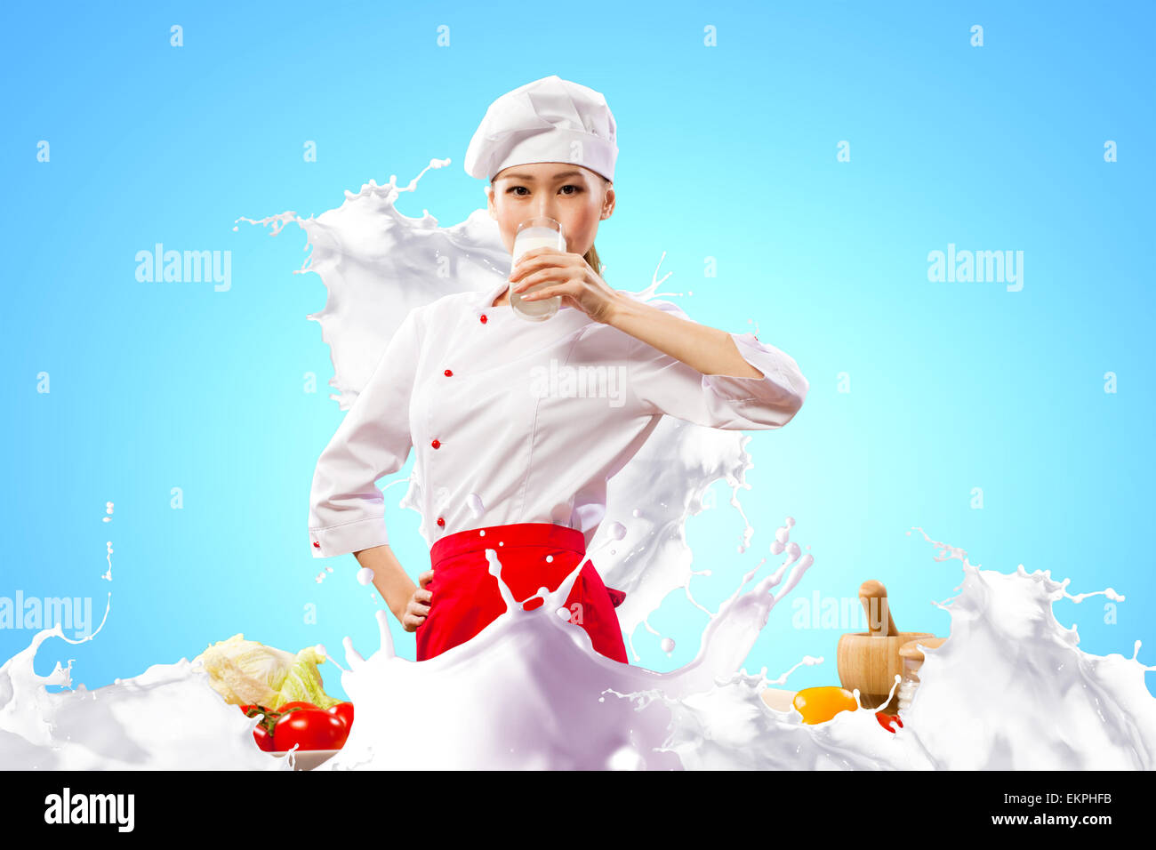 Asian female cook against milk splashes Stock Photo - Alamy