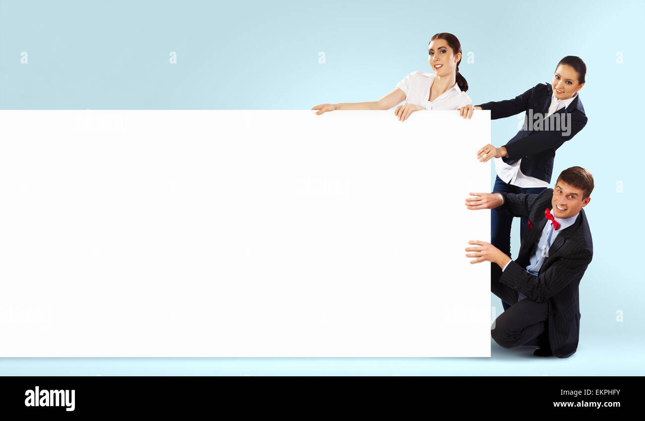 Three young people holding banner Stock Photo - Alamy