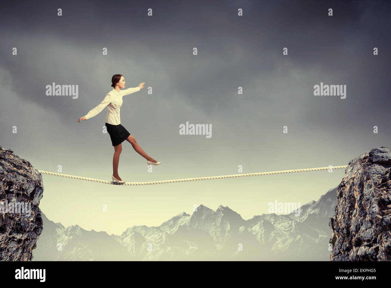 Businesswoman balancing on rope Stock Photo - Alamy