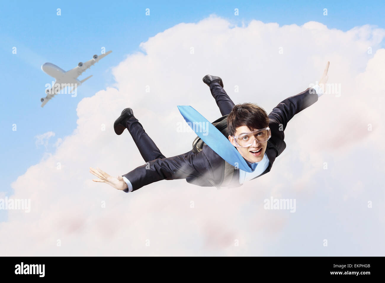 Young businessman flying with parachute on back Stock Photo - Alamy