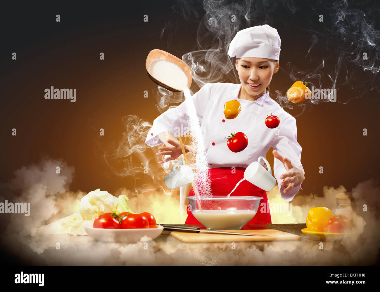 Asian female cooking with magic Stock Photo - Alamy