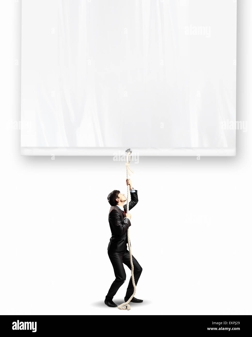 Businessman pulling banner Stock Photo - Alamy