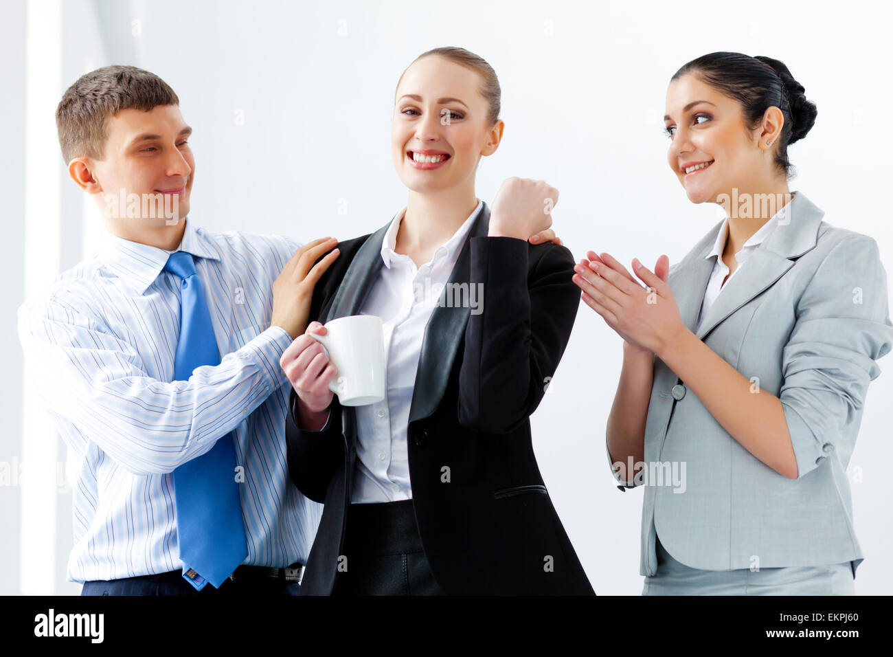 Three young business people laughing Stock Photo - Alamy