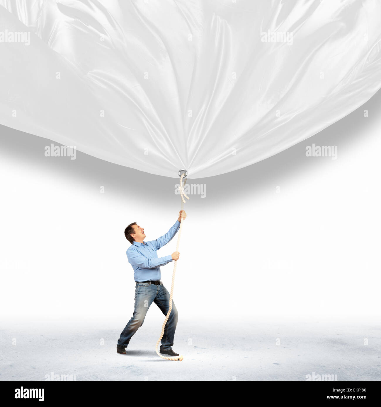 Businessman pulling banner Stock Photo - Alamy