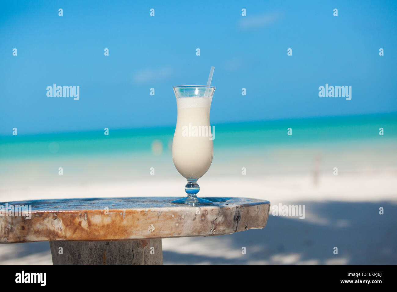 White pina colada on the beach table Stock Photo - Alamy