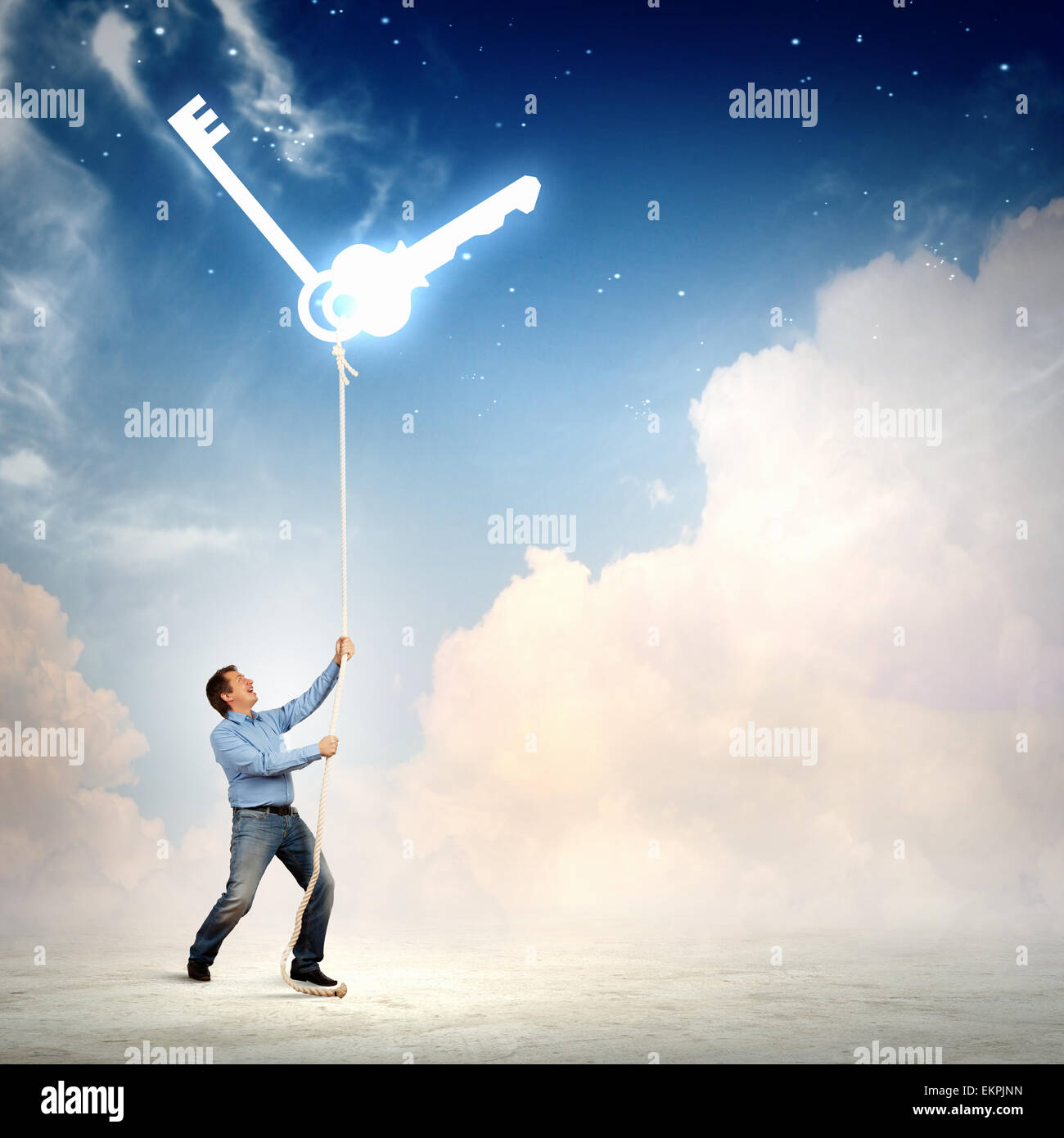 Adult man pulling rope with keys Stock Photo - Alamy