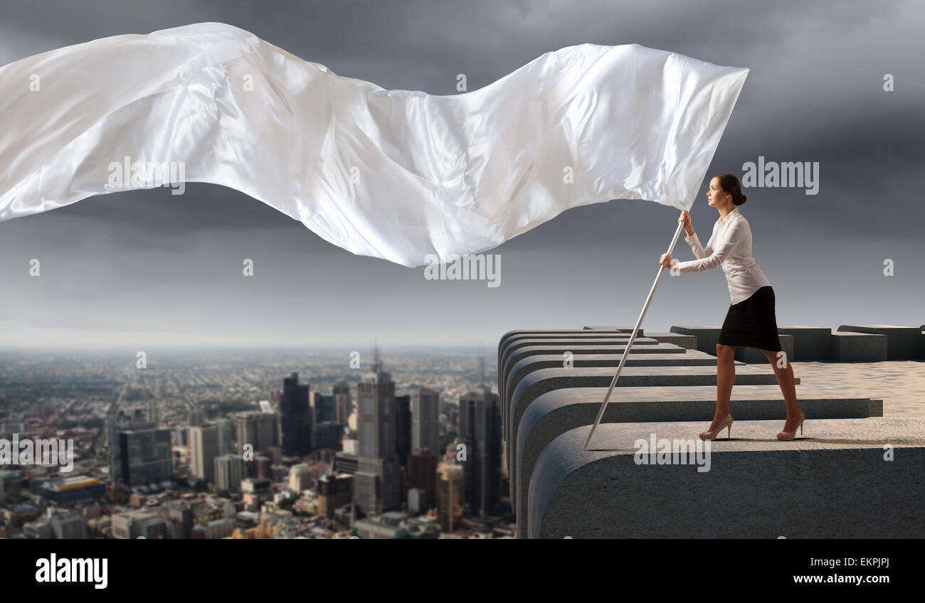Businesswoman holding white flag Stock Photo - Alamy