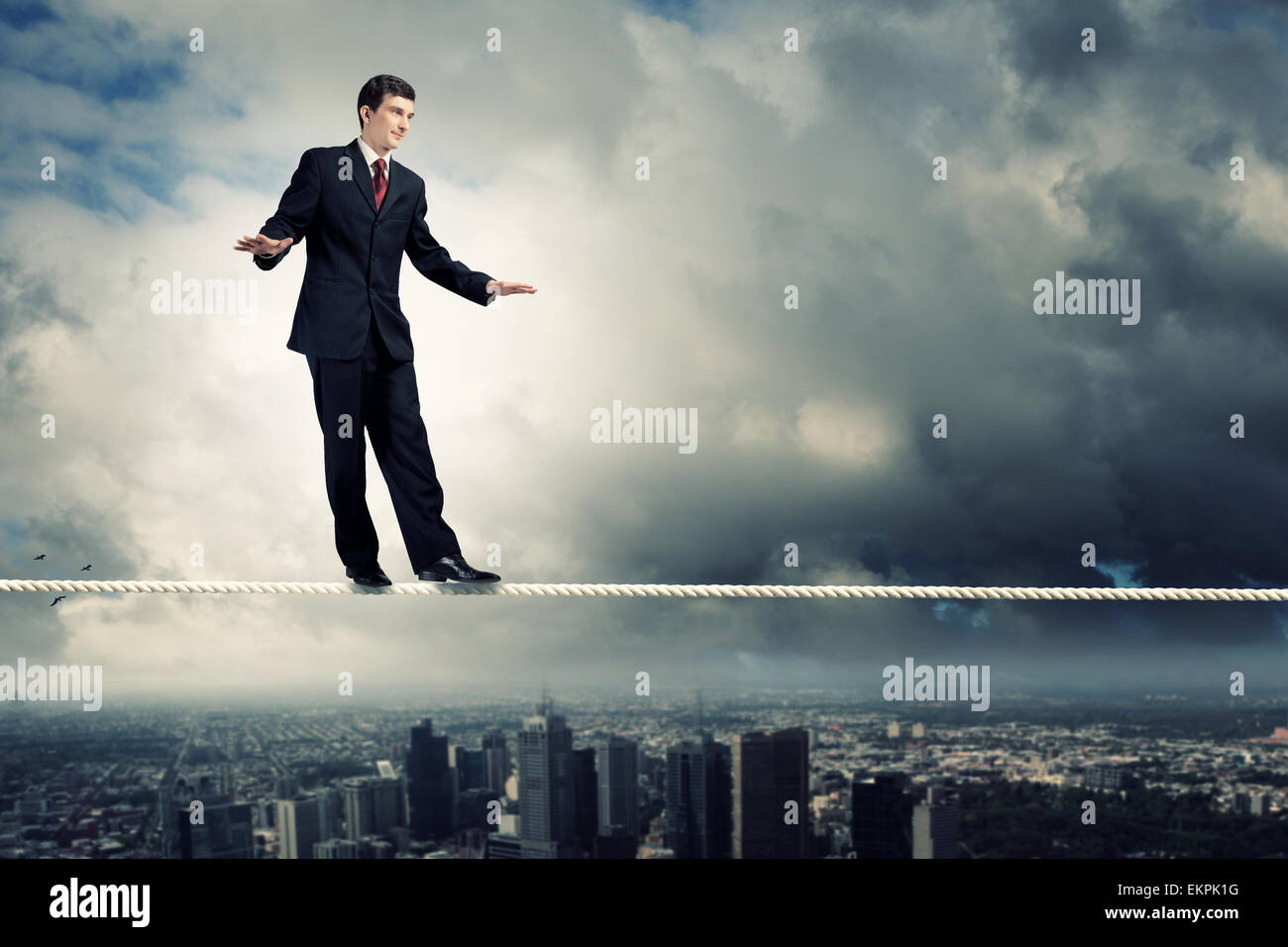 Businessman balancing on rope Stock Photo - Alamy