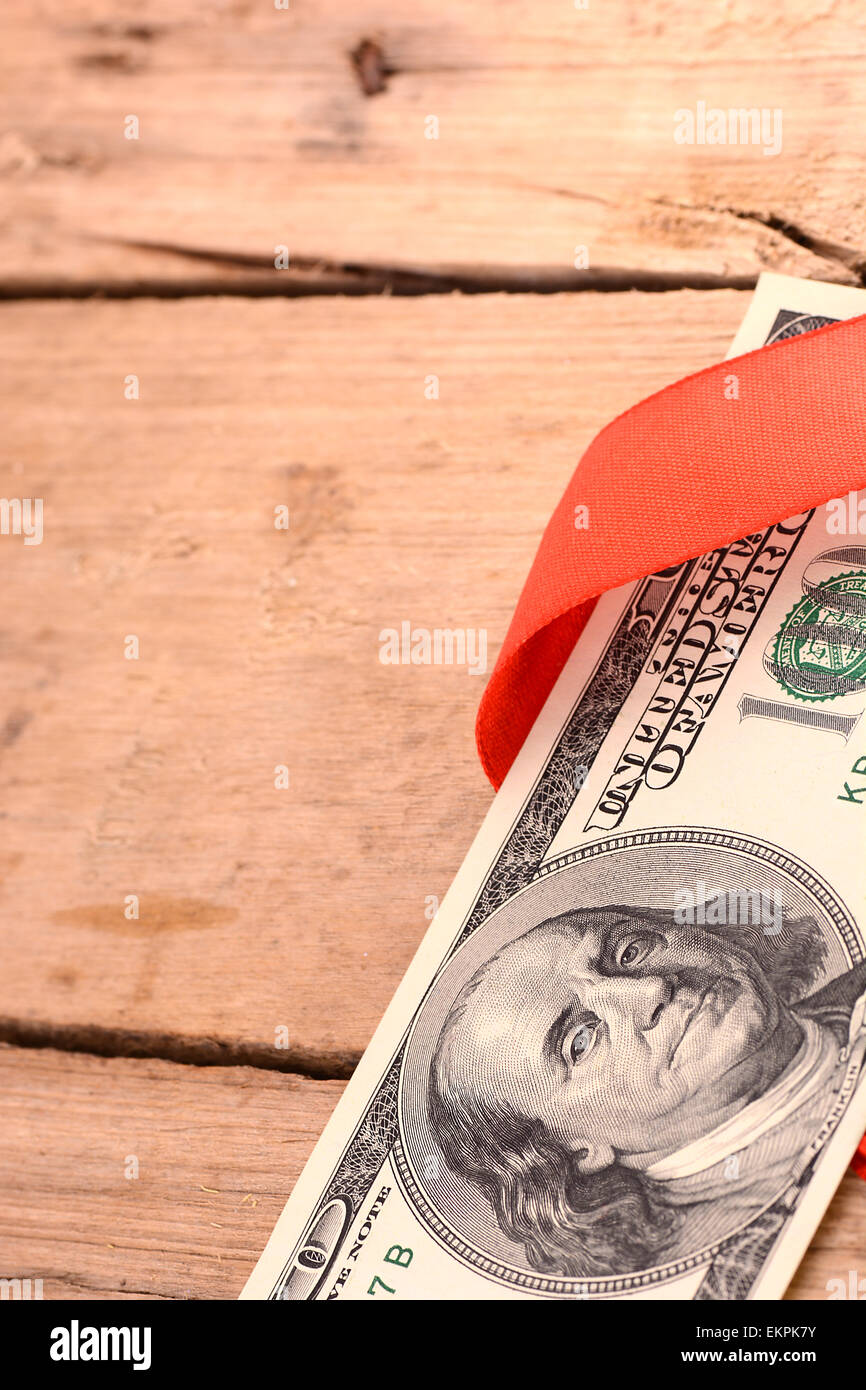 One Hundred Dollar Bills Wrapper in Red Ribbon Stock Photo - Alamy
