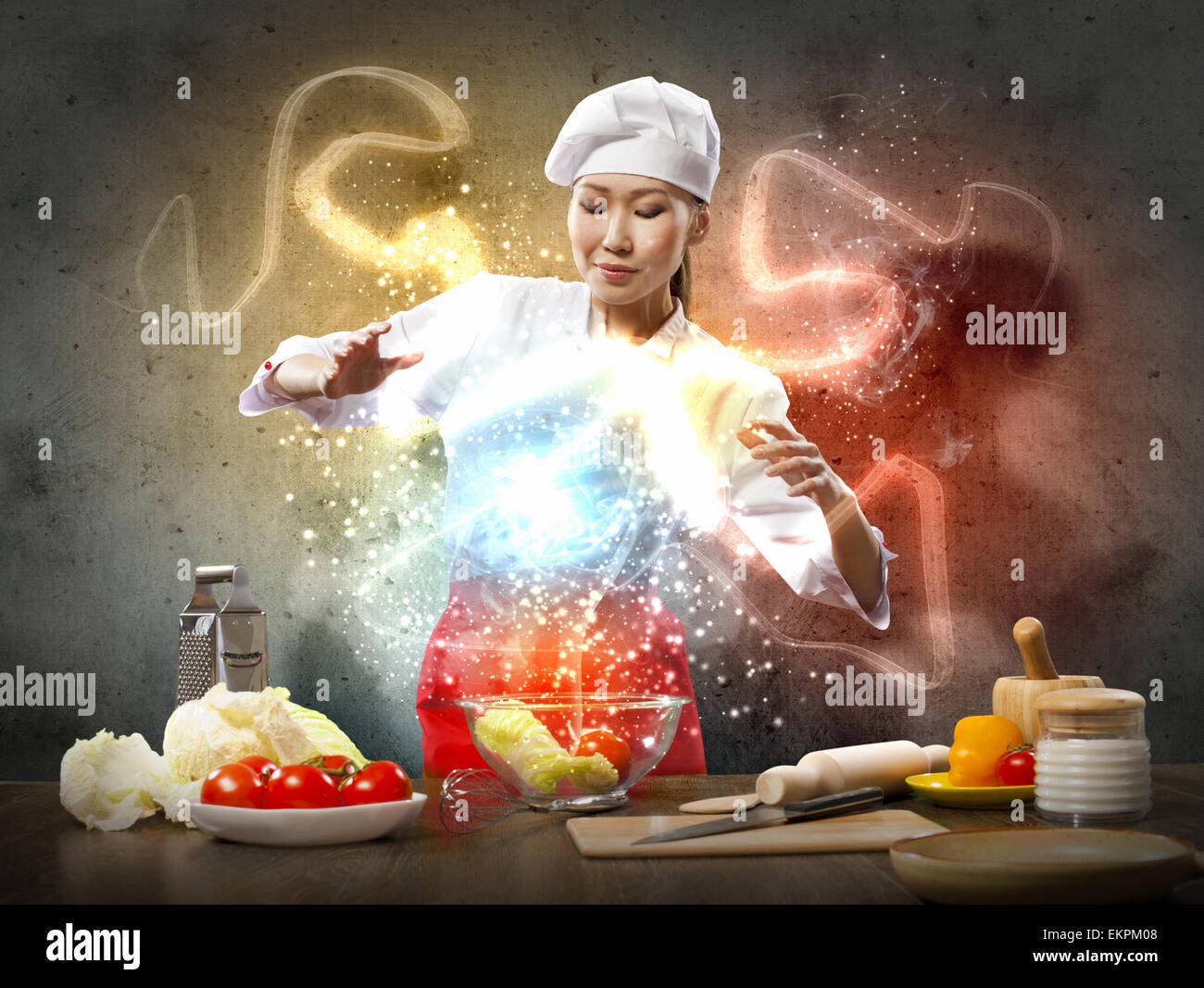 Asian female cooking with magic Stock Photo - Alamy