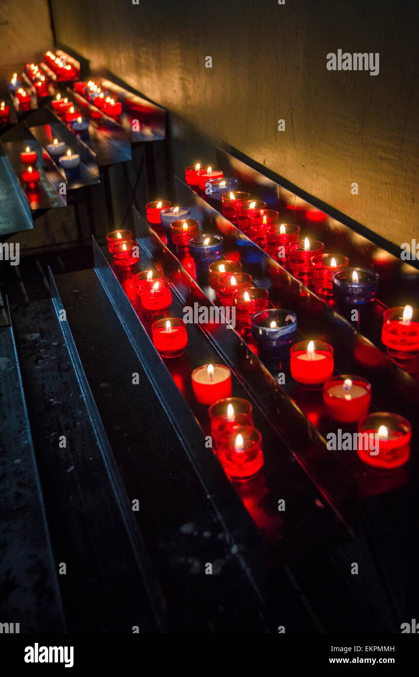 Rows of red candles in a church Stock Photo - Alamy
