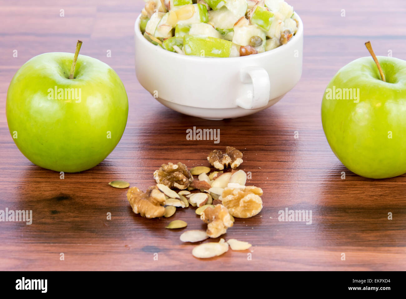 healthy snack: apple salad with almonds, walnuts and pumpkin seeds ...