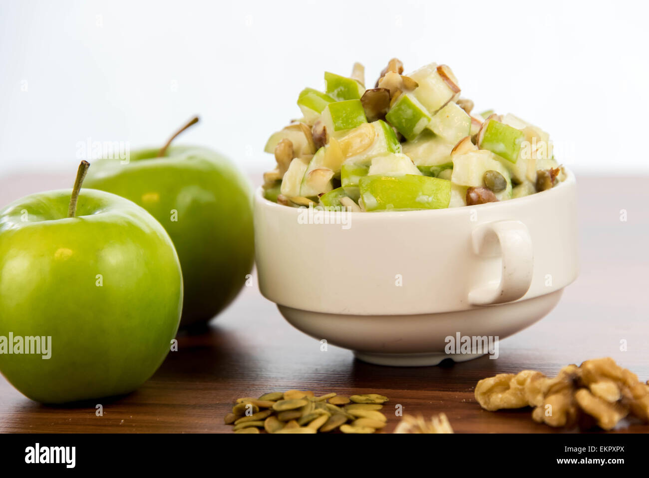 healthy snack: apple salad with almonds, walnuts and pumpkin seeds ...