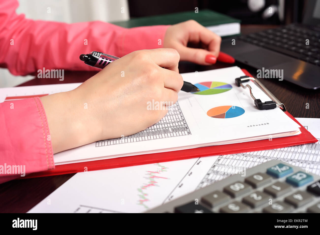 woman checking budget or a payroll with a calculator Stock Photo - Alamy