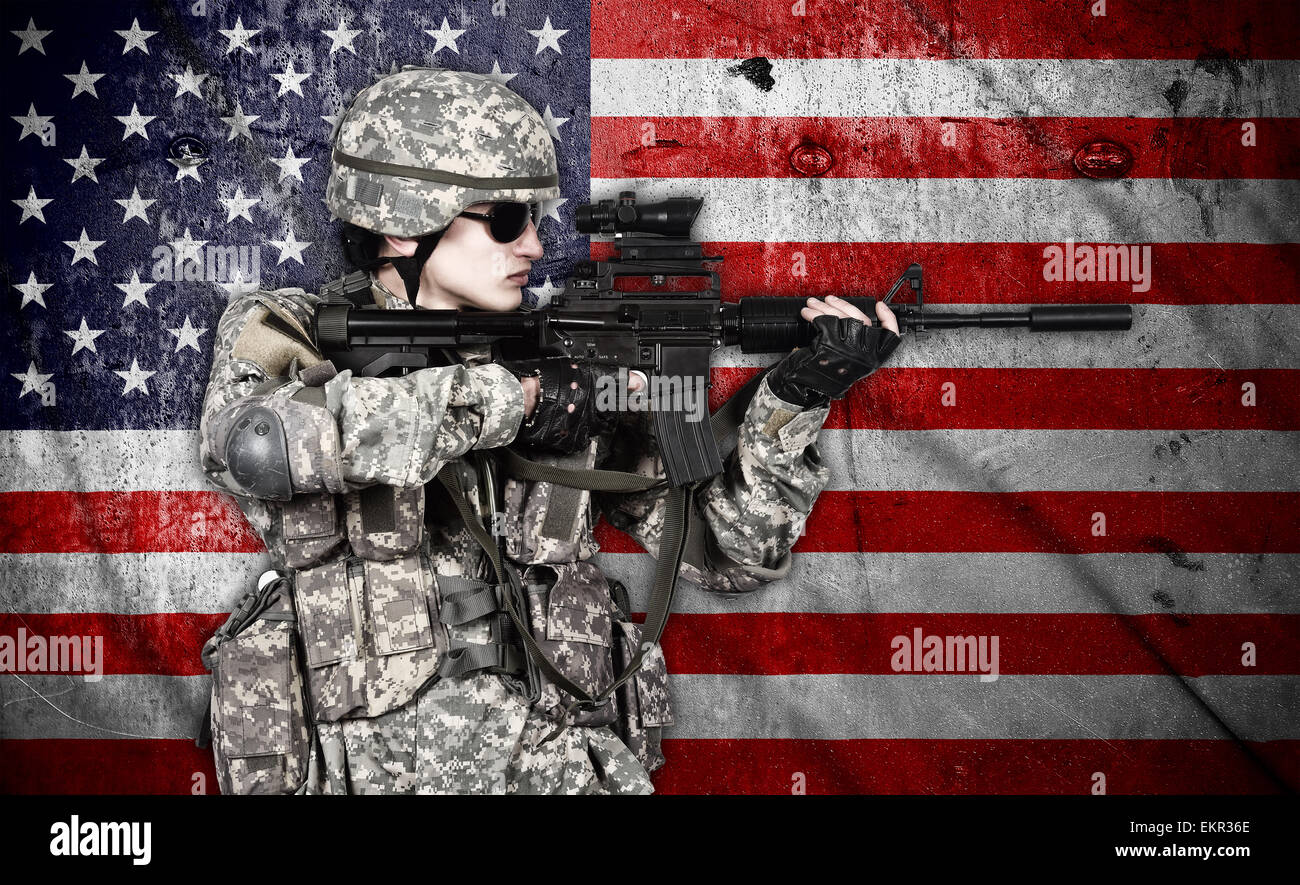 soldier holding rifle on american flag background Stock Photo - Alamy