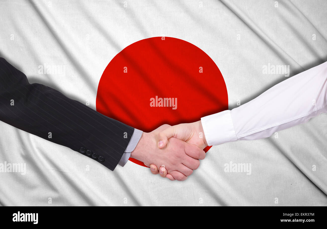 handshake on a Japan flag background Stock Photo - Alamy