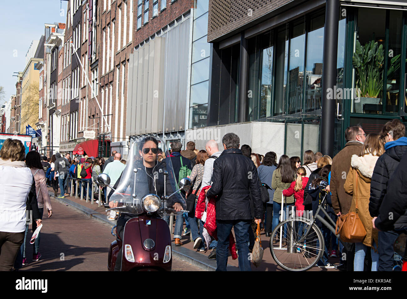 Long queues of people wait to go into the historic Anne Frank house ...