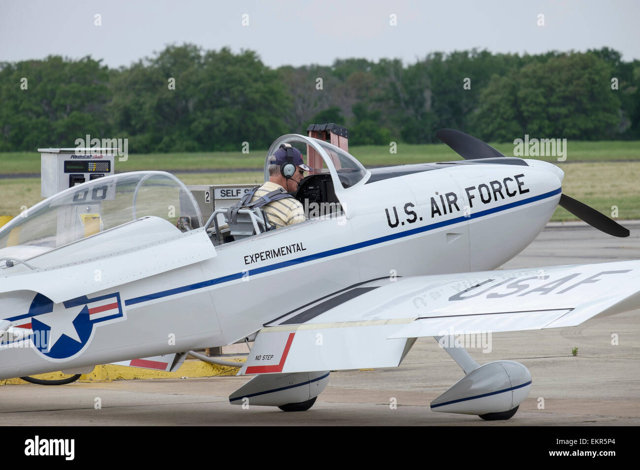 Pilot in cockpit with open canopy of small airplane preparing for ...