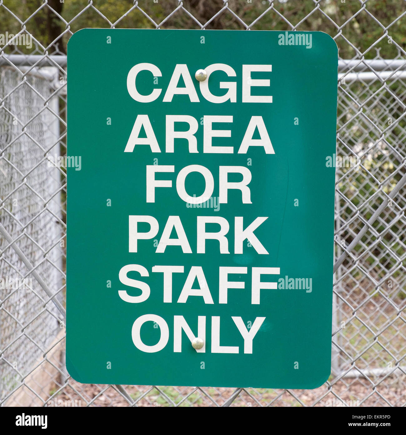 Funny neighborhood park staff cage sign Stock Photo - Alamy