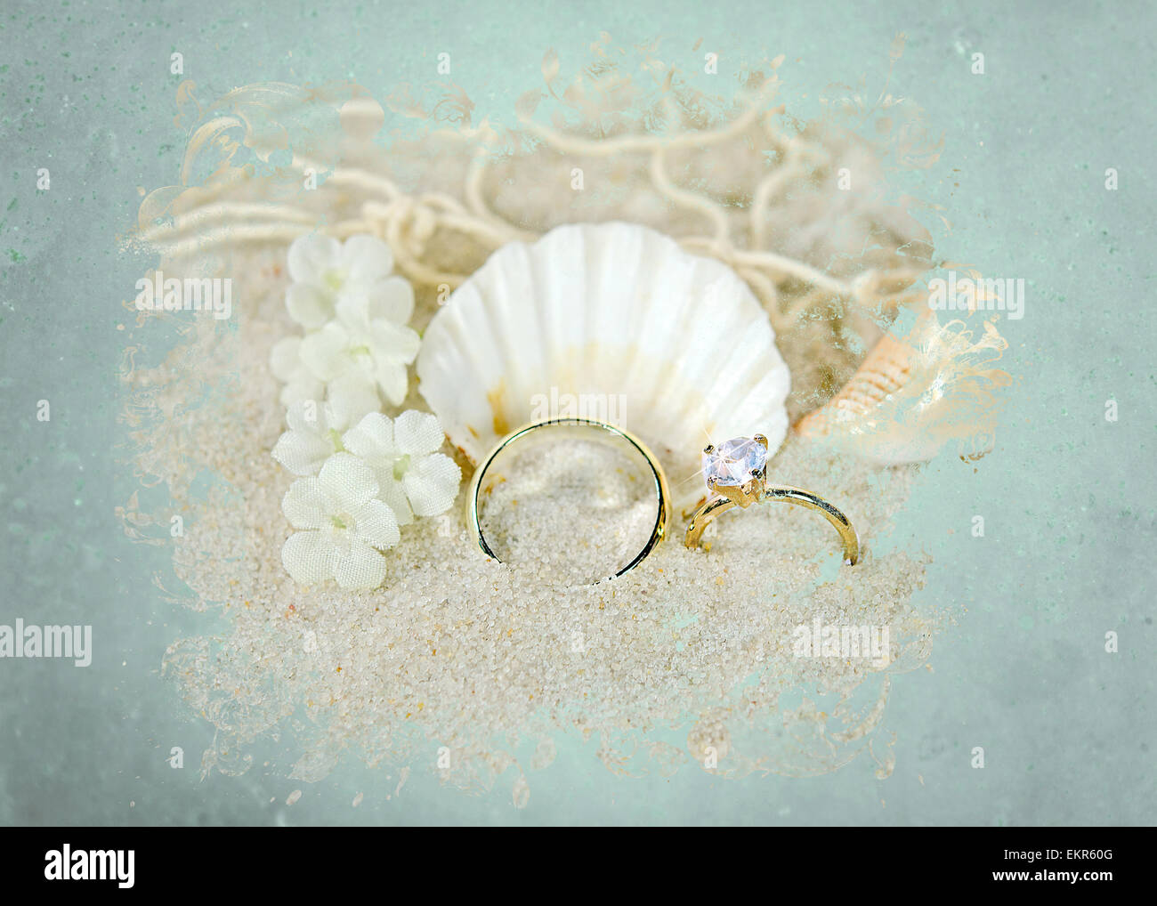 Seashells and wedding rings in sand with textured frame Stock Photo - Alamy
