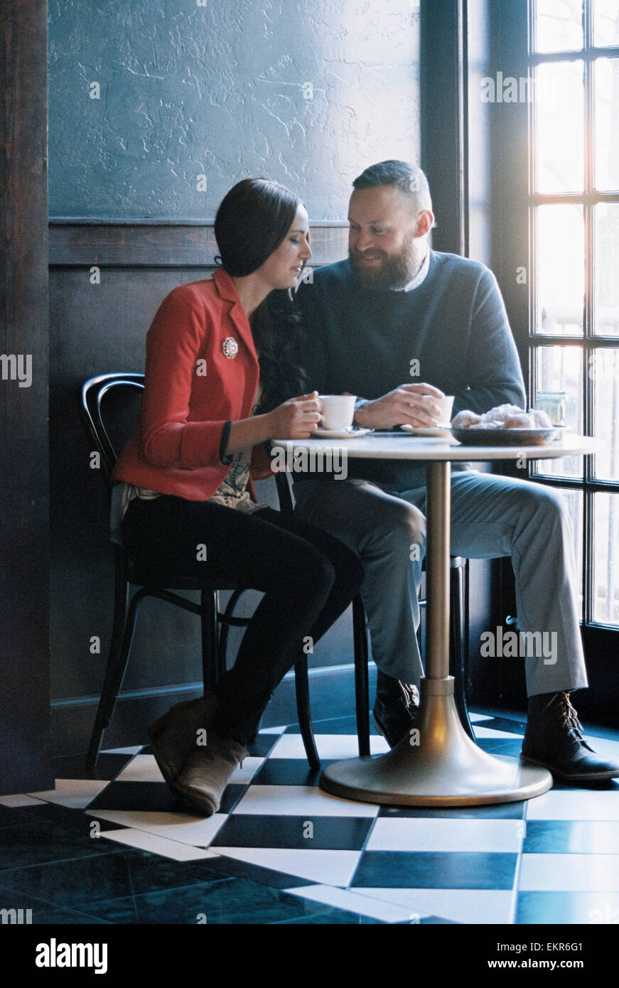Couple sitting side by side at table hi-res stock photography and ...