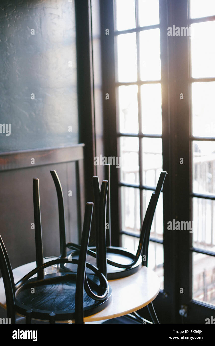 A table in a cafe with the chairs up, at the end of the day Stock Photo ...