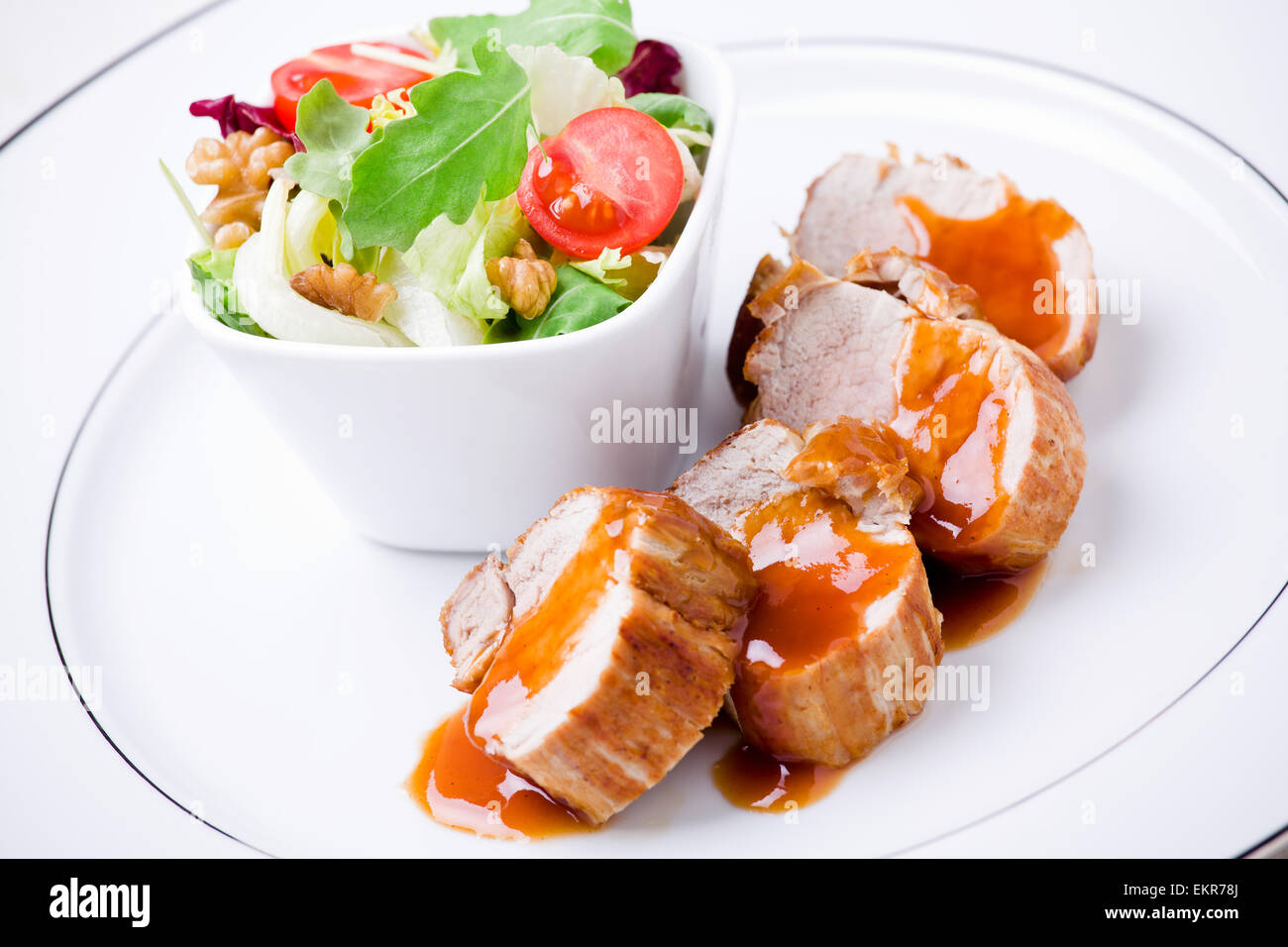 Close up photograph of a meal of pork filet with salad Stock Photo - Alamy