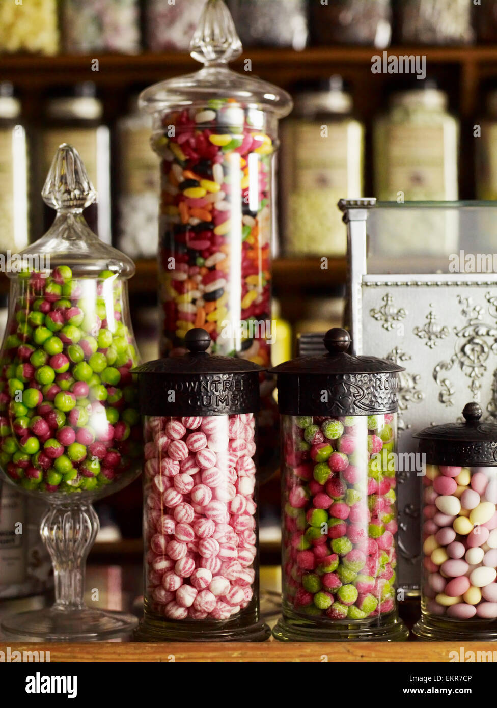Traditional sweets displayed in tall glass jars on the shelves of a ...