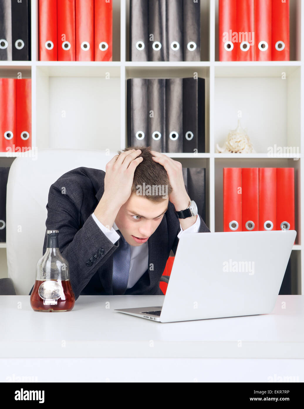 shocked young businessman looking on laptop in his office Stock Photo ...