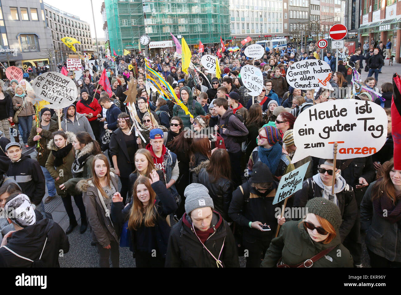 Activists and G7 opponents carry protest signs which read 'today is a ...